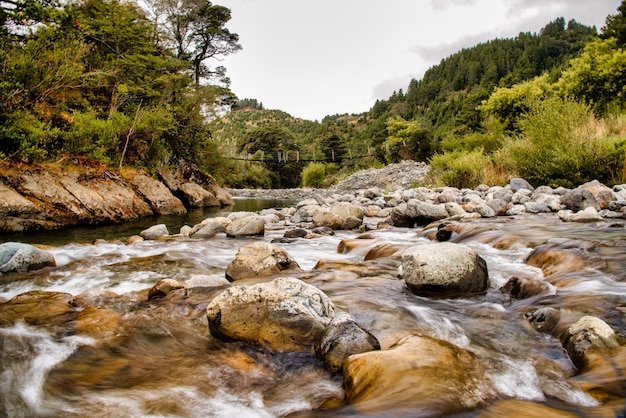 Premium Photo | Fast flowing river rapids rushing past the boulders ... Premium Photo | Fast flowing river rapids rushing past the boulders ...