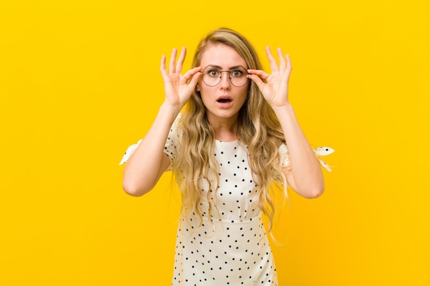 Premium Photo Feeling Shocked Amazed And Surprised Holding Glasses