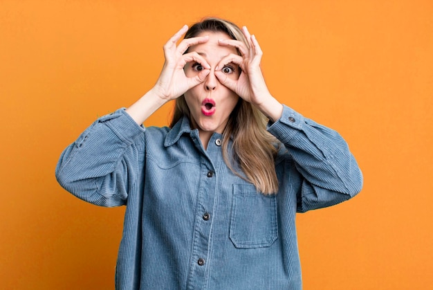 Premium Photo Feeling Shocked Amazed And Surprised Holding Glasses