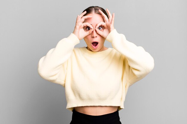 Premium Photo Feeling Shocked Amazed And Surprised Holding Glasses