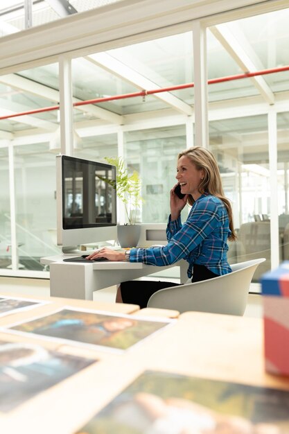 Premium Photo | Female graphic designer talking on mobile phone while ... Premium Photo | Female graphic designer talking on mobile phone while ...