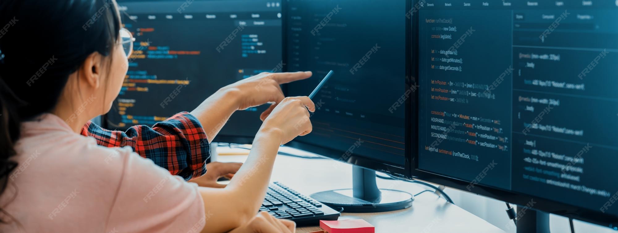 Premium Photo | Female programer explain while pointing code displayed on computer professional ...