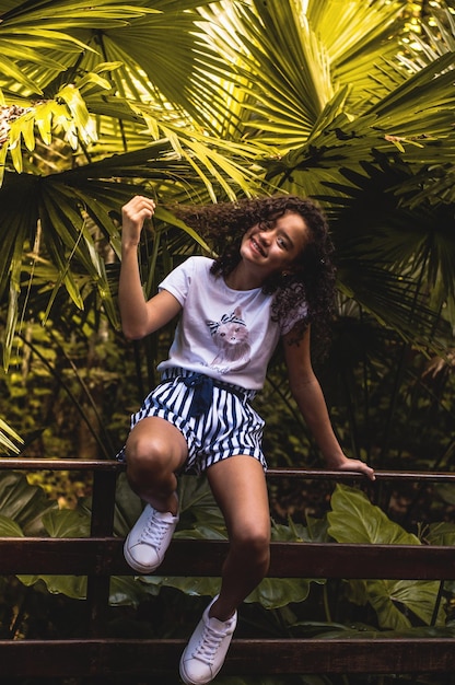 Premium Photo Full Length Portrait Of Girl Smiling While Sitting On