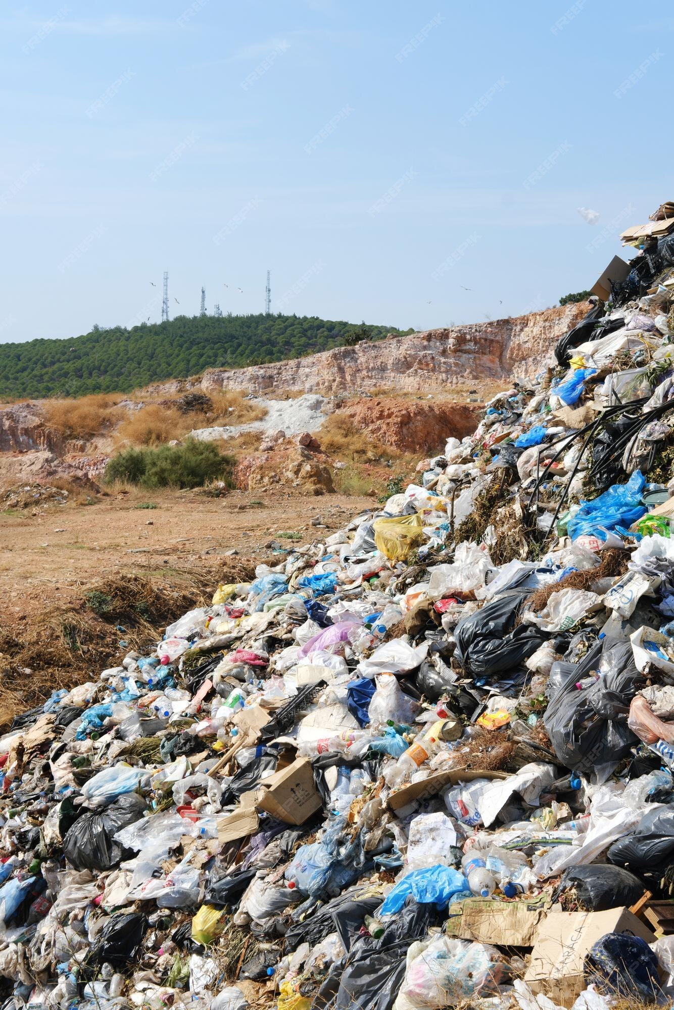 Premium Photo | Garbage Dump Site with Green Trees and Antennas Distant Premium Photo | Garbage Dump Site with Green Trees and Antennas Distant