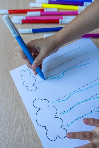 Premium Photo | Girl doing fine graphomotor skills exercises Premium Photo | Girl doing fine graphomotor skills exercises