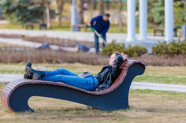 Premium Photo The Girl Lies On A Sun Lounger In The Park With Her