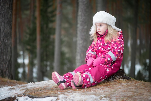 Premium Photo Girl Sitting On Tree Stump In Forest