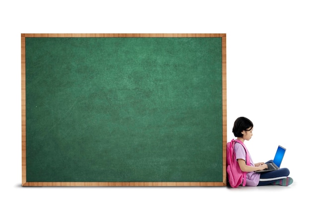 Premium Photo Girl Using Laptop By Blackboard Against White Background