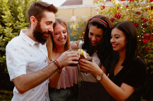 Premium Photo | Group of cheerful friends clinking glasses at party Premium Photo | Group of cheerful friends clinking glasses at party