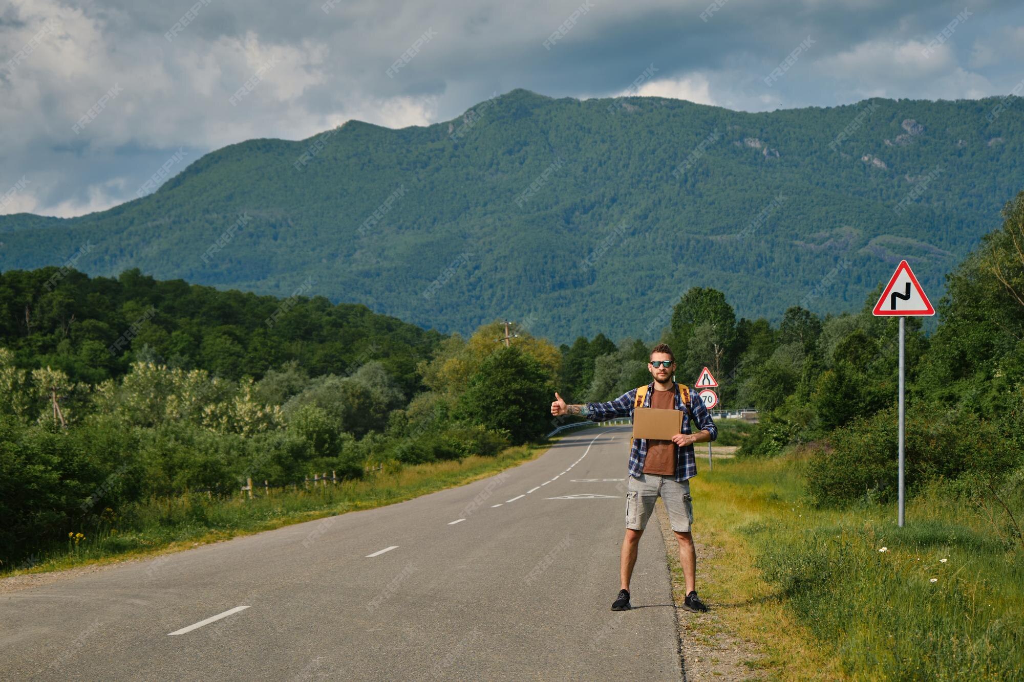 Premium Photo | Guy went on trip alone trying to stop passing car ... Premium Photo | Guy went on trip alone trying to stop passing car ...