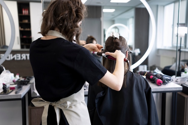 Premium Photo | Hairdresser taking care of her client Premium Photo | Hairdresser taking care of her client