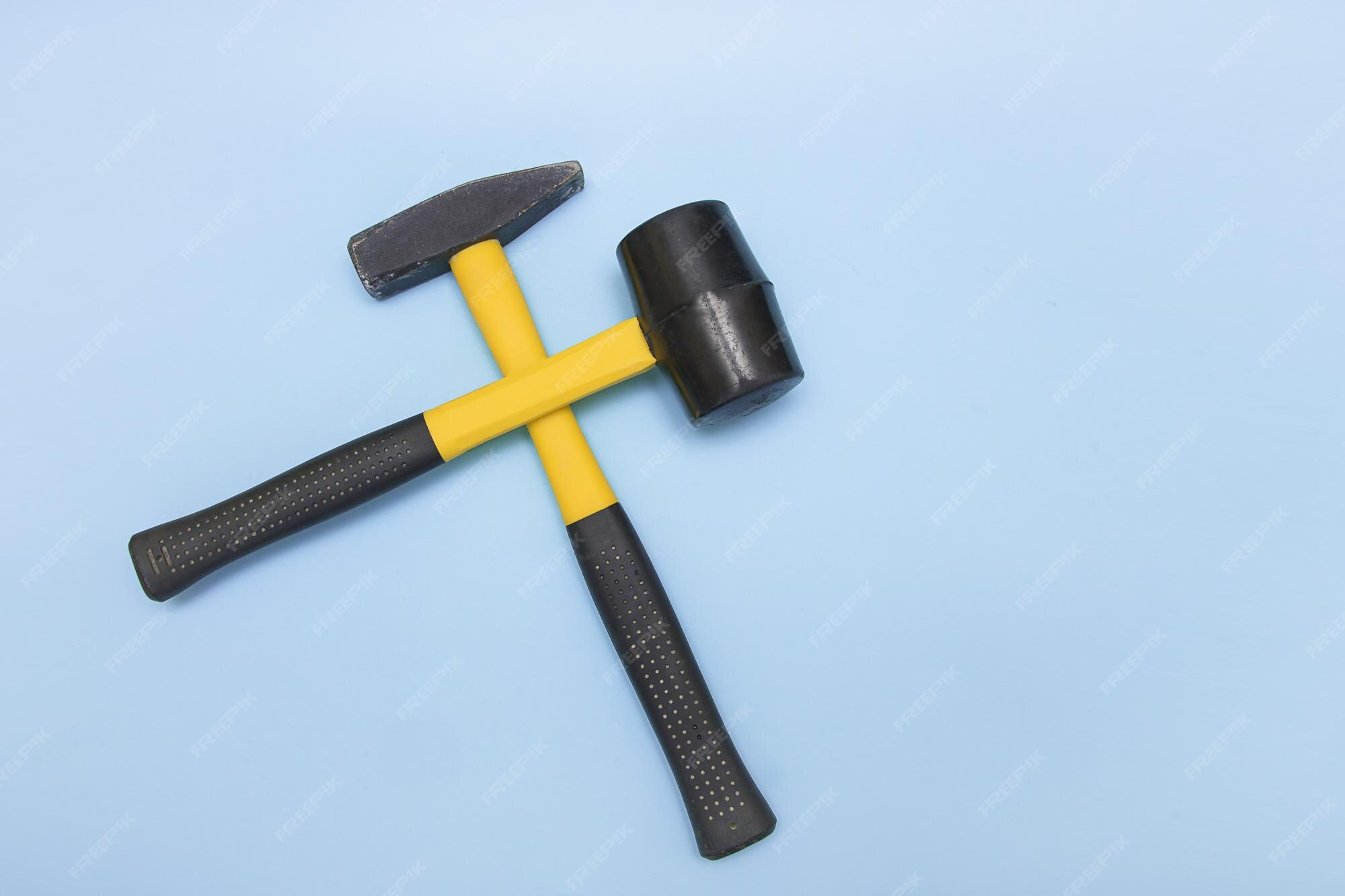 Premium Photo Hammer And Mallet On A Light Blue Background Crosswise