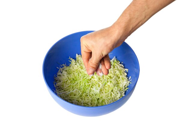 Premium Photo The Hand Of Cook Salts Lettuce From A Young Green Cabbage Isolated On A White