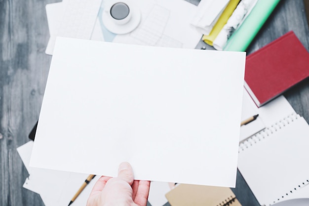 Premium Photo | Hand holding empty paper Premium Photo | Hand holding empty paper