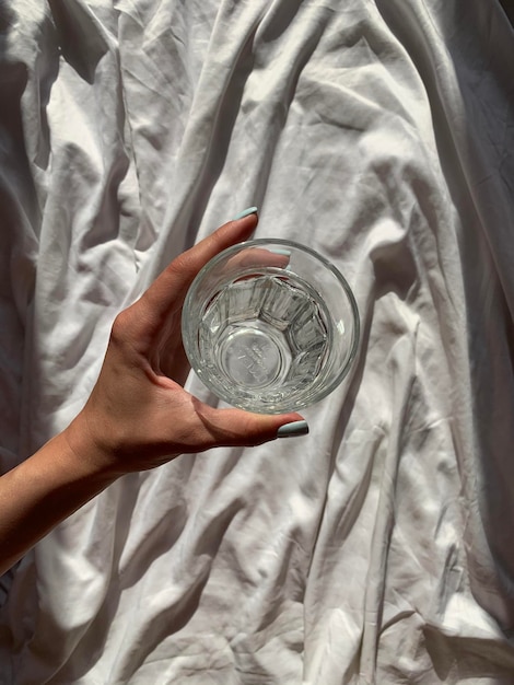 Premium Photo | A hand holding a glass of water Premium Photo | A hand holding a glass of water