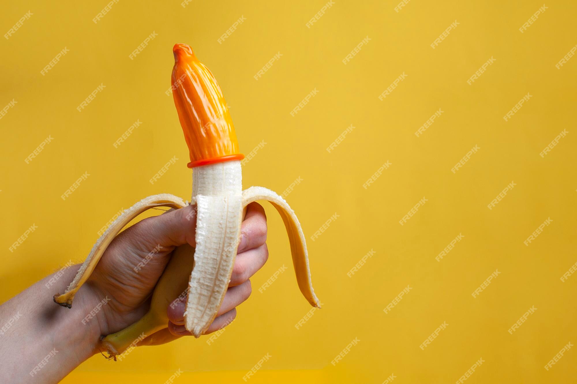 Premium Photo Hand Holds A Banana With A Condom A Contraceptive