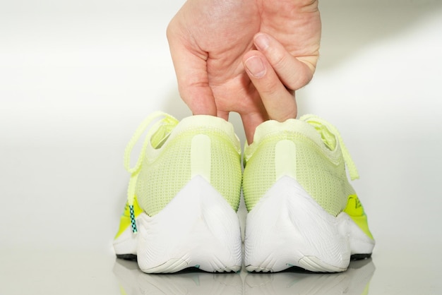 Premium Photo | Hand pick running shoes for start exercising Premium Photo | Hand pick running shoes for start exercising