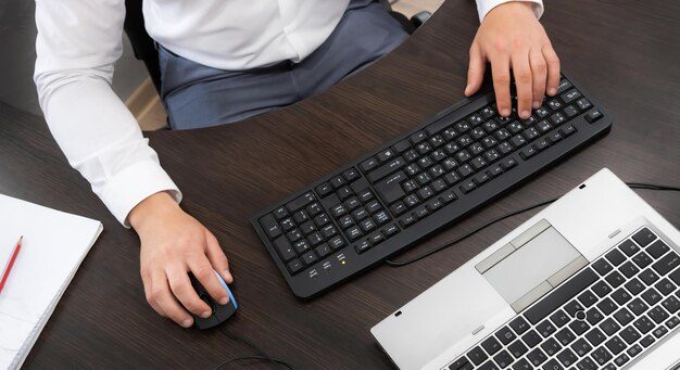 Premium Photo | Hands working on keyboard and laptop from above Premium Photo | Hands working on keyboard and laptop from above