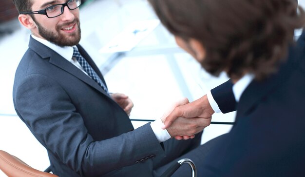 Premium Photo | Handshake business partners in front of the open laptop Premium Photo | Handshake business partners in front of the open laptop