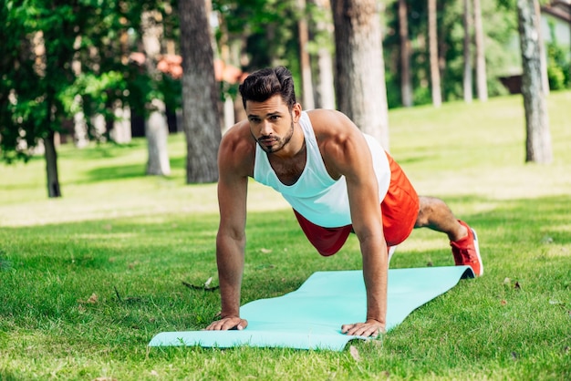 Premium Photo | Handsome man doing plank exercise on fitness mat Premium Photo | Handsome man doing plank exercise on fitness mat