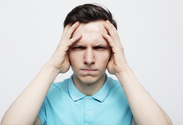 Premium Photo | Handsome young man suffering from headache Premium Photo | Handsome young man suffering from headache