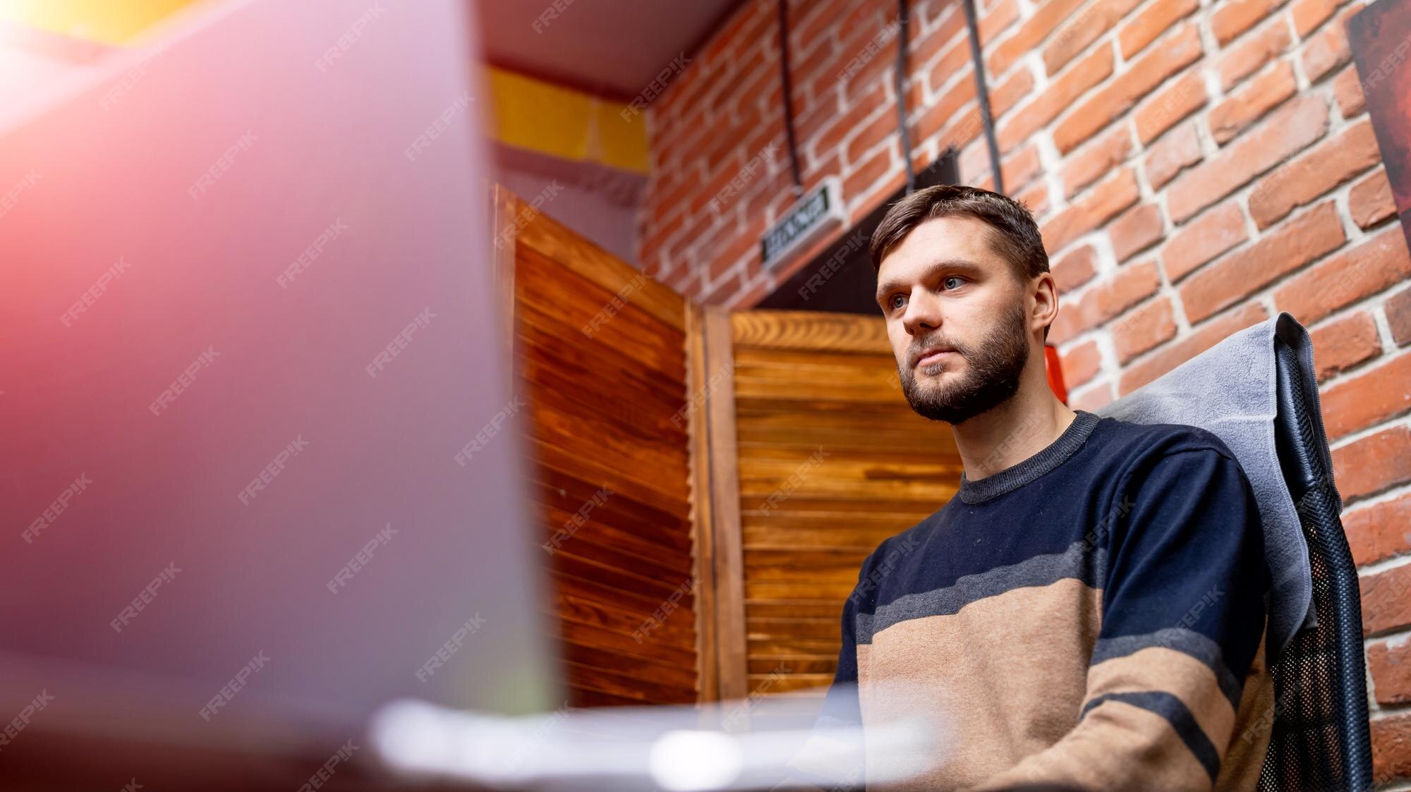 Premium Photo | Handsome young programmer working in office developing ...