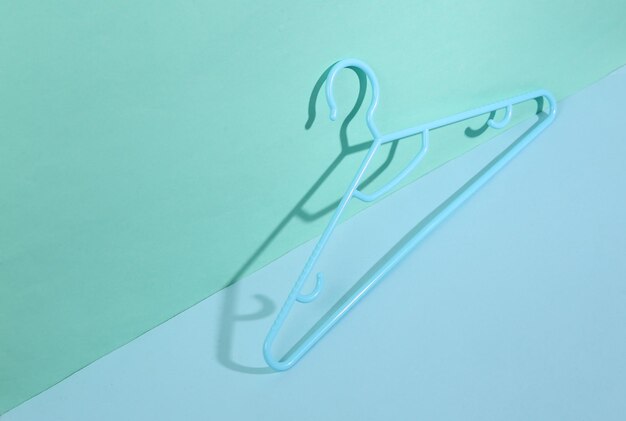 Premium Photo | Hanger on blue background with trendy shadows creative ... Premium Photo | Hanger on blue background with trendy shadows creative ...