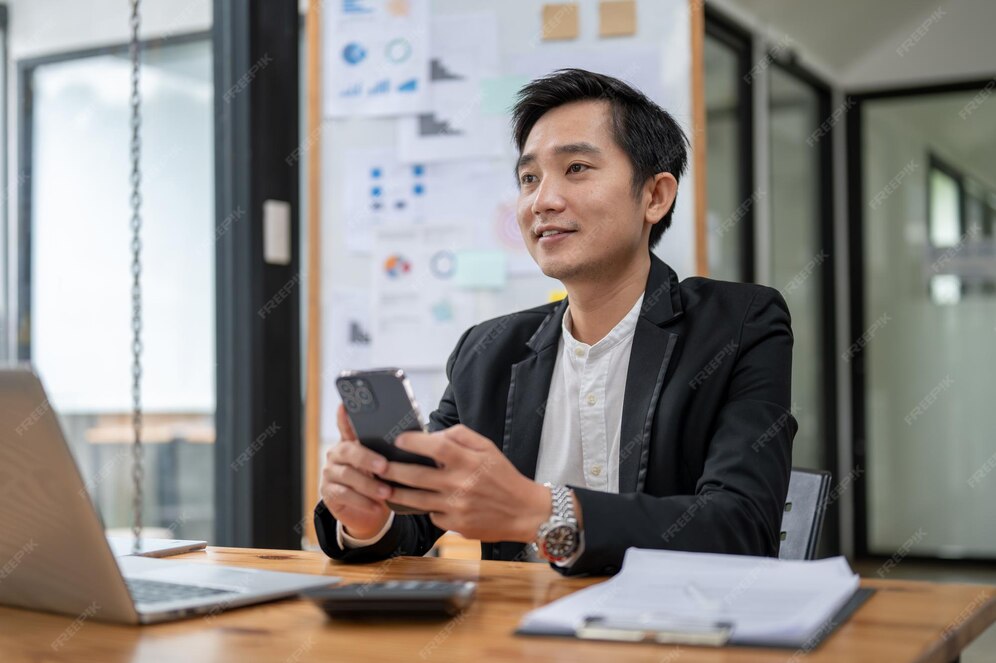 Premium Photo | A happy and professional asian businessman using his ... Premium Photo | A happy and professional asian businessman using his ...