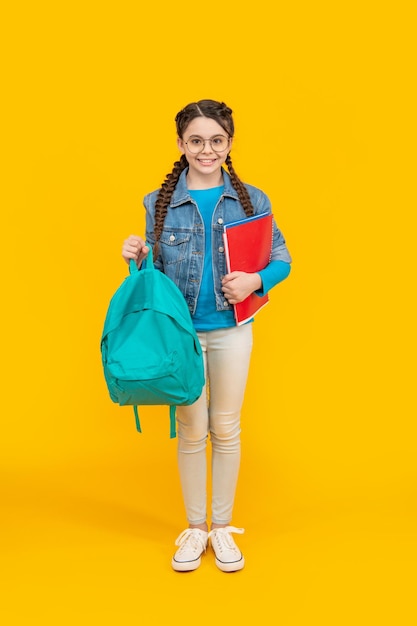 Premium Photo | Happy teenage girl holding school bag yellow background ... Premium Photo | Happy teenage girl holding school bag yellow background ...