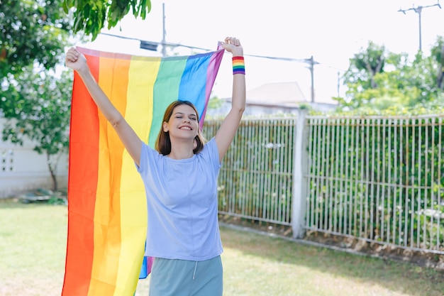 Premium Photo Happy Woman Rising Rainbow Flag For Support Lgbt