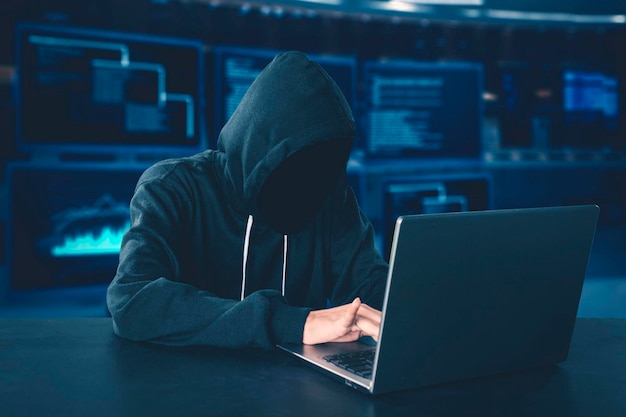 Premium Photo | Hooded unknown hacker using laptop computer Premium Photo | Hooded unknown hacker using laptop computer