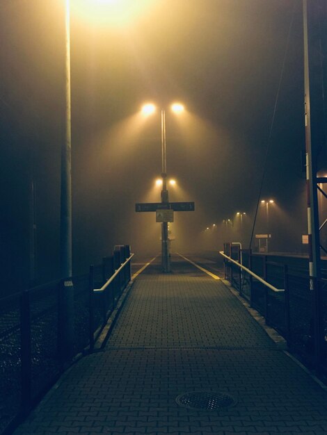 Premium Photo Illuminated Street Lights On Footpath At Night