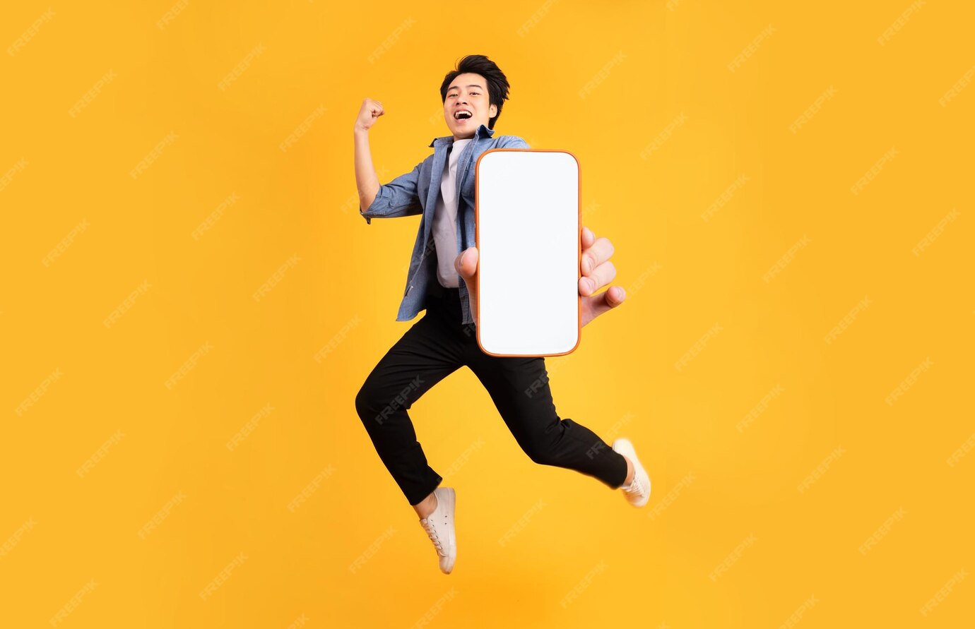 Premium Photo Image Of Jumping Up Asian Man Holding Smartphone In