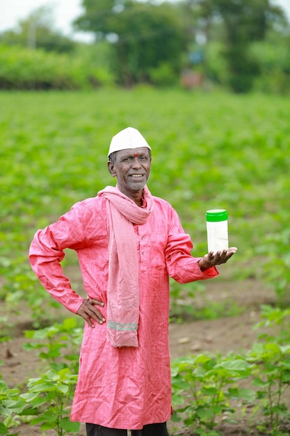 Premium Photo | Indian happy farmer holding empty bottle in hands happy ... Premium Photo | Indian happy farmer holding empty bottle in hands happy ...