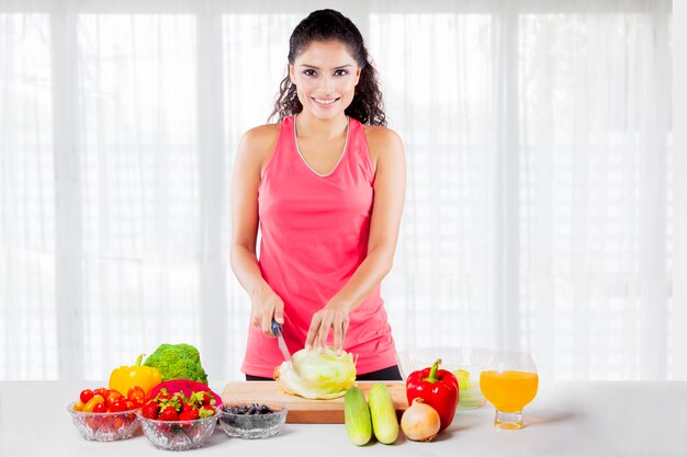 Premium Photo Indian Woman Cutting Lettuce Preparing Dinner In Kitchen