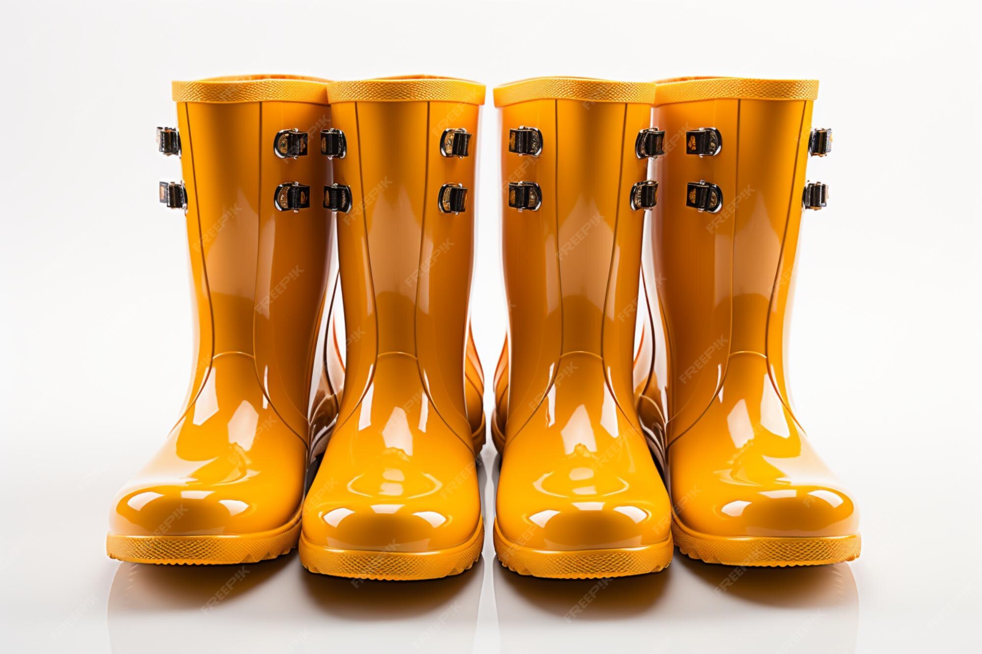 Premium Ai Image Isolated Footwear Array Of Yellow Rain Boots Stands Out Against White Background