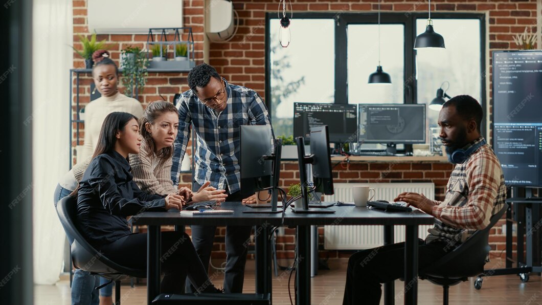 Premium Photo | Junior developers collaborating on group project compiling algorithm asking ...