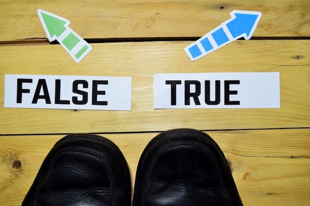 Premium Photo | Low section of man with false true text on floor Premium Photo | Low section of man with false true text on floor
