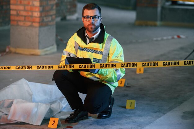 Premium Photo Male Detective Is Collecting Evidence In A Crime Scene