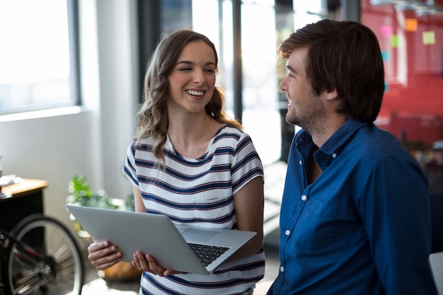 Premium Photo | Male and female business executives interacting while ... Premium Photo | Male and female business executives interacting while ...