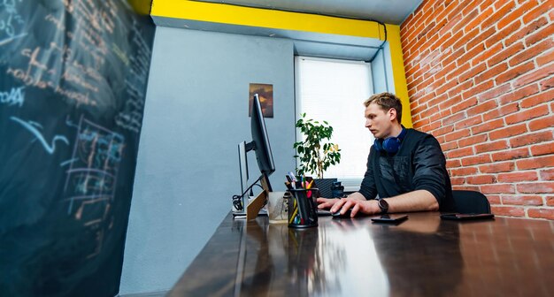 Premium Photo | Male programmer working on desktop computer near ...