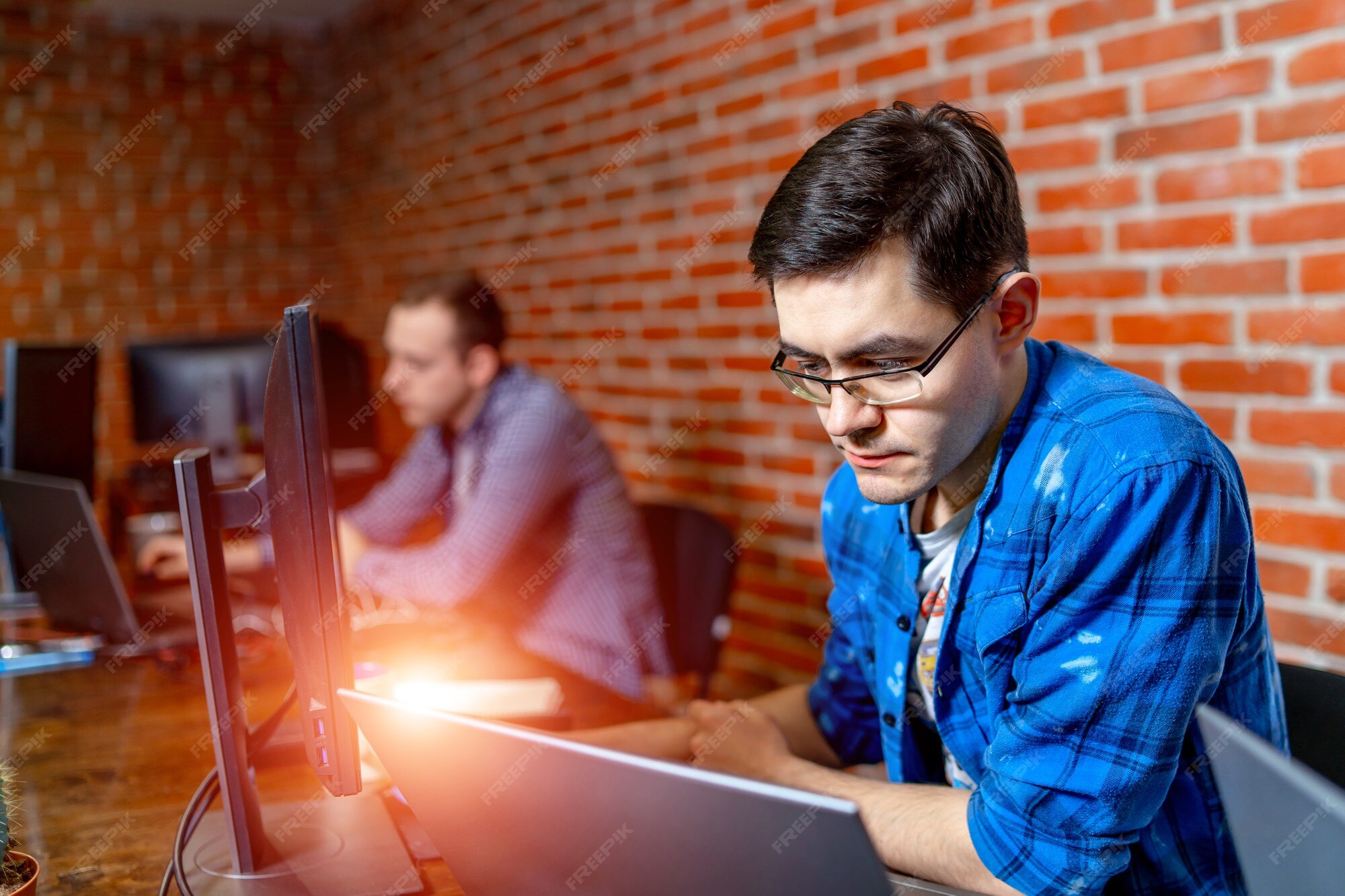 Premium Photo | Male programmer working on desktop computer near ...