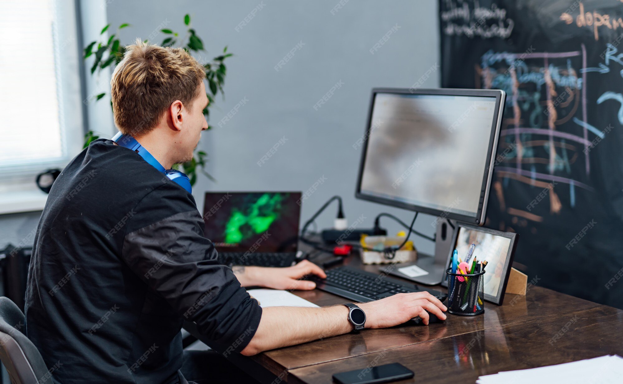 Premium Photo | Male programmer working on desktop computer near ...