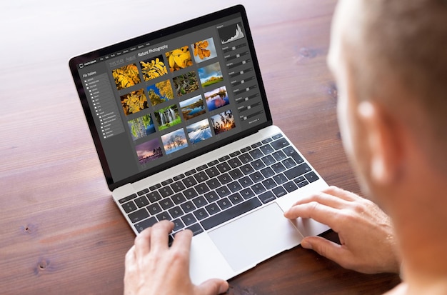 Premium Photo | Man editing photo files on laptop computer Premium Photo | Man editing photo files on laptop computer