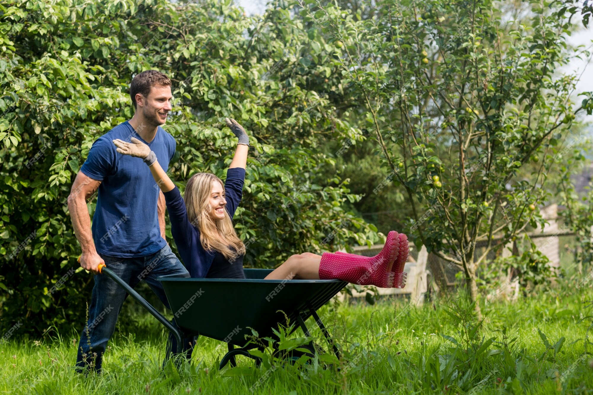 Premium Photo | Man pushing his girlfriend in a wheelbarrow Premium Photo | Man pushing his girlfriend in a wheelbarrow