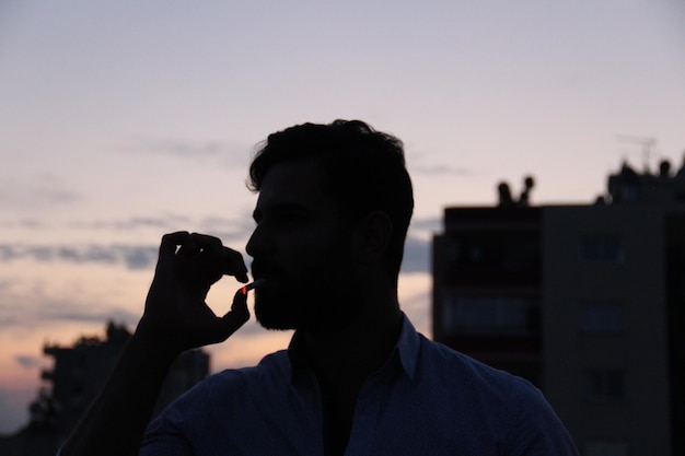 Premium Photo Man Smoking Cigarette Against Sky During Sunset
