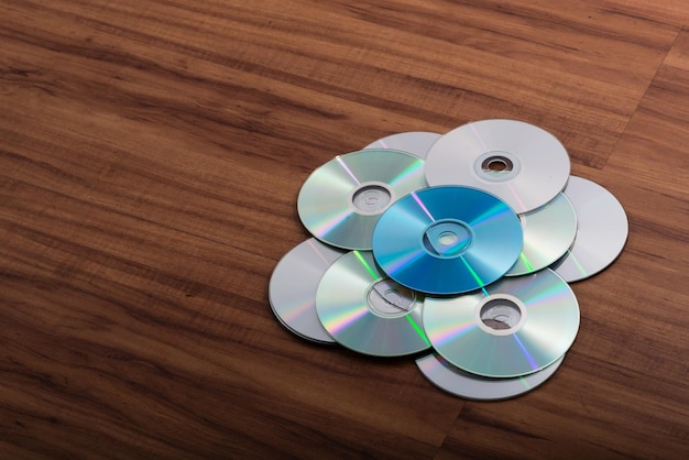 Premium Photo | Many CDs isolated on wooden background Premium Photo | Many CDs isolated on wooden background