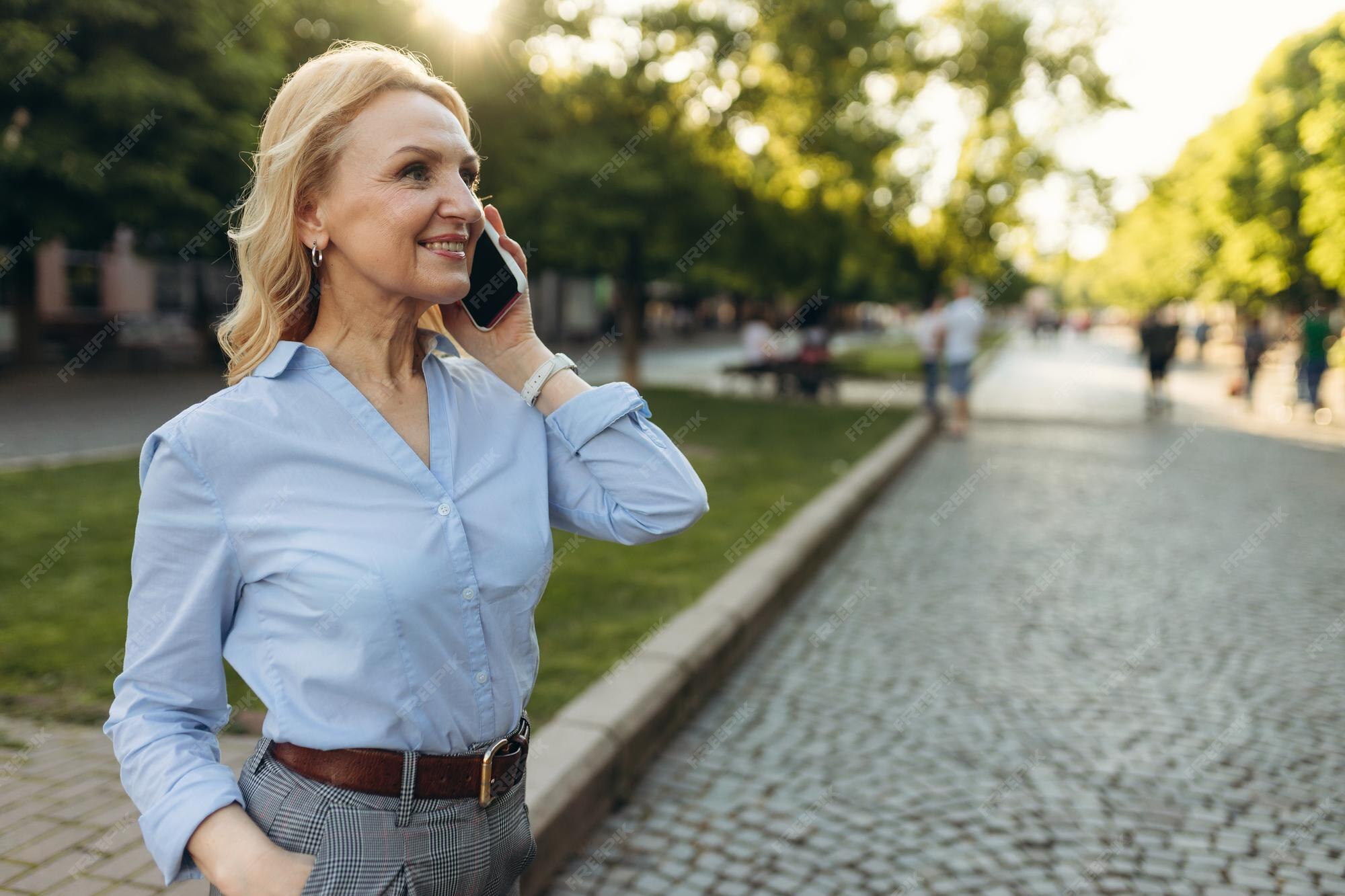 Premium Photo | Mature businesswoman talking on cell phone enjoying a ... Premium Photo | Mature businesswoman talking on cell phone enjoying a ...