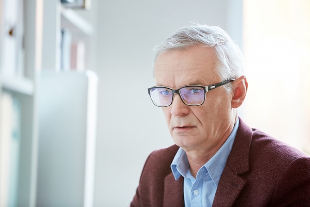 Premium Photo | Mature man working at office Premium Photo | Mature man working at office
