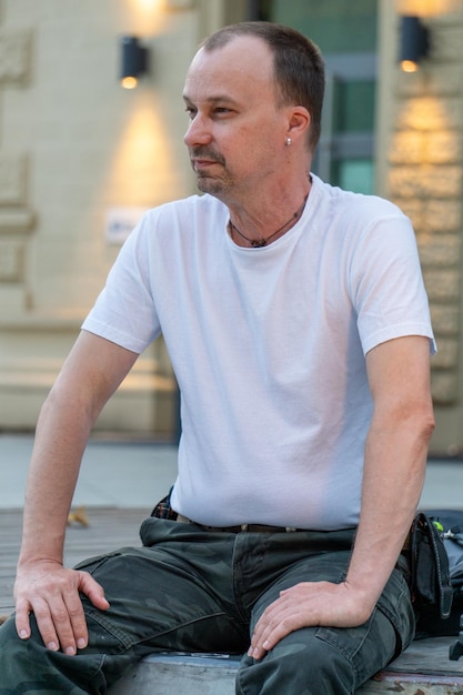 Premium Photo | Mid adult man sitting outdoors Premium Photo | Mid adult man sitting outdoors